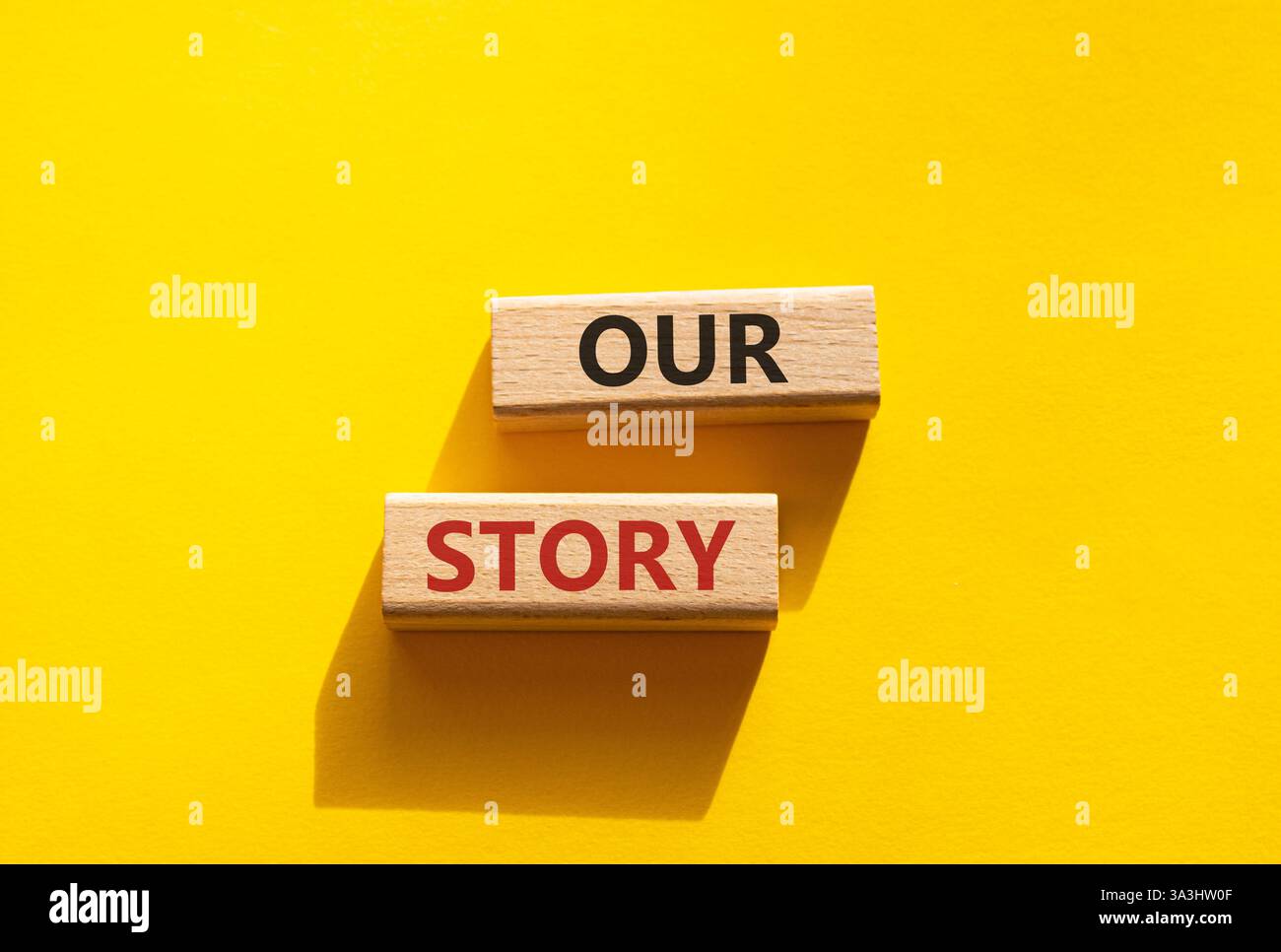 Our story symbol. Wooden blocks with words Our story Beautiful yellow ...