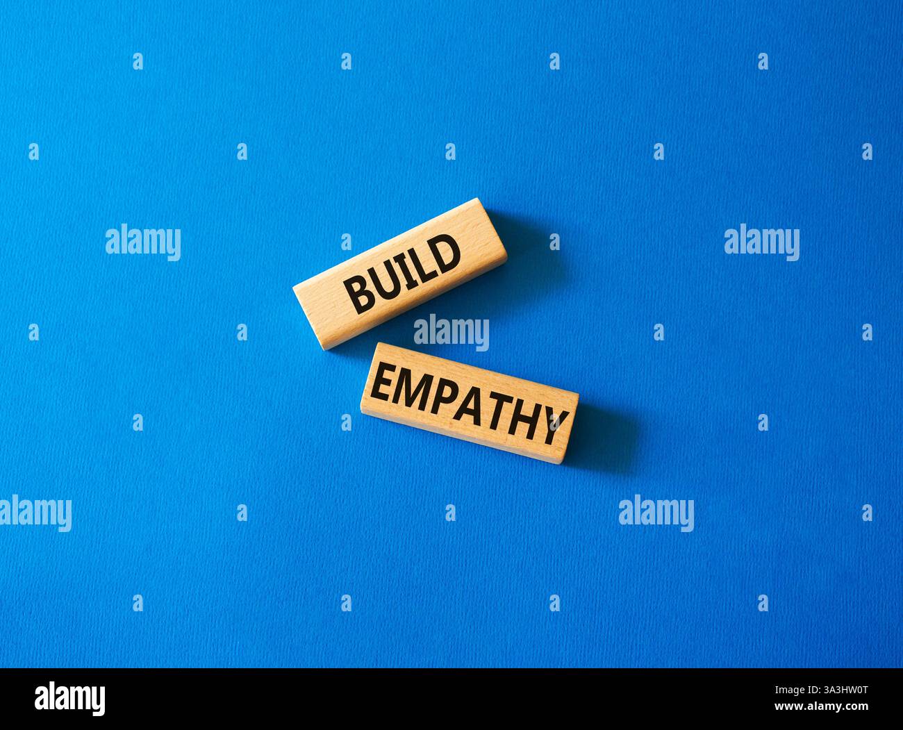 Build empathy symbol. Wooden blocks with words Build empathy. Beautiful ...