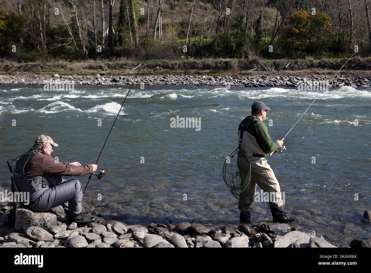 Two men fish in the river Sil, on March 16, 2025, in Quiroga, Lugo ...