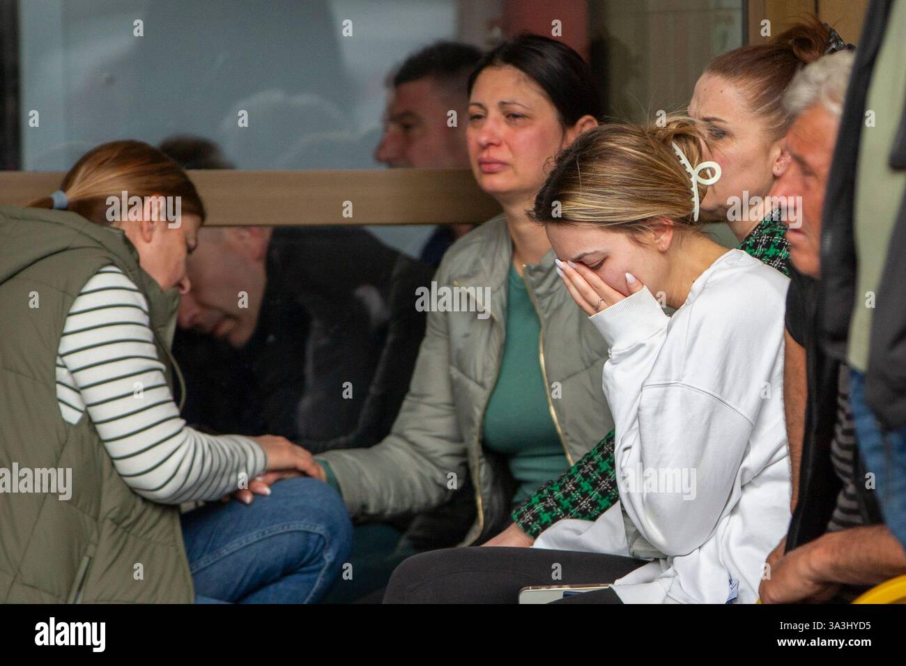 A woman cries outside a hospital in the town of Kocani, North Macedonia ...