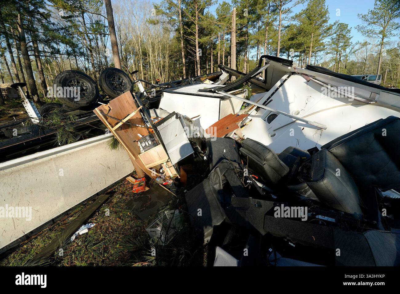 Furniture and kitchen appliances are exposed in the remnants of a ...