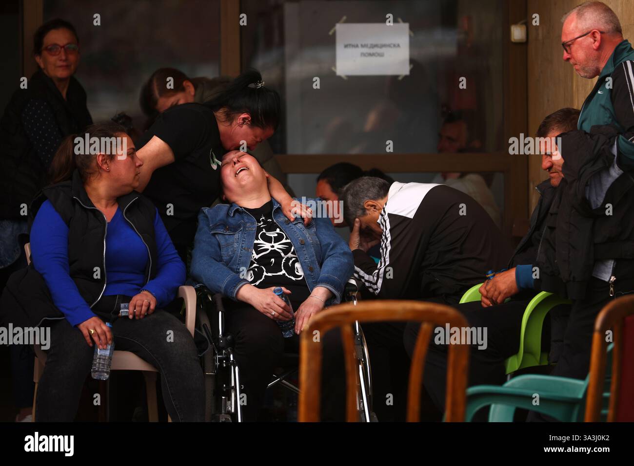Women cry outside a hospital in the town of Kocani, North Macedonia ...