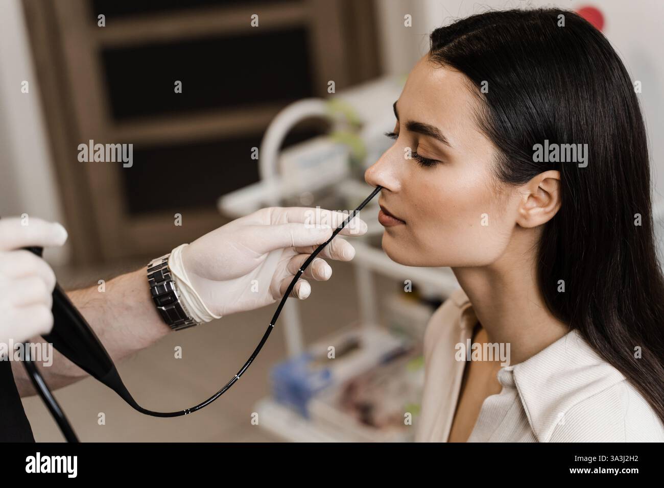 ENT doctor using fibrolaryngoscope to examine and treat nose. ENT ...