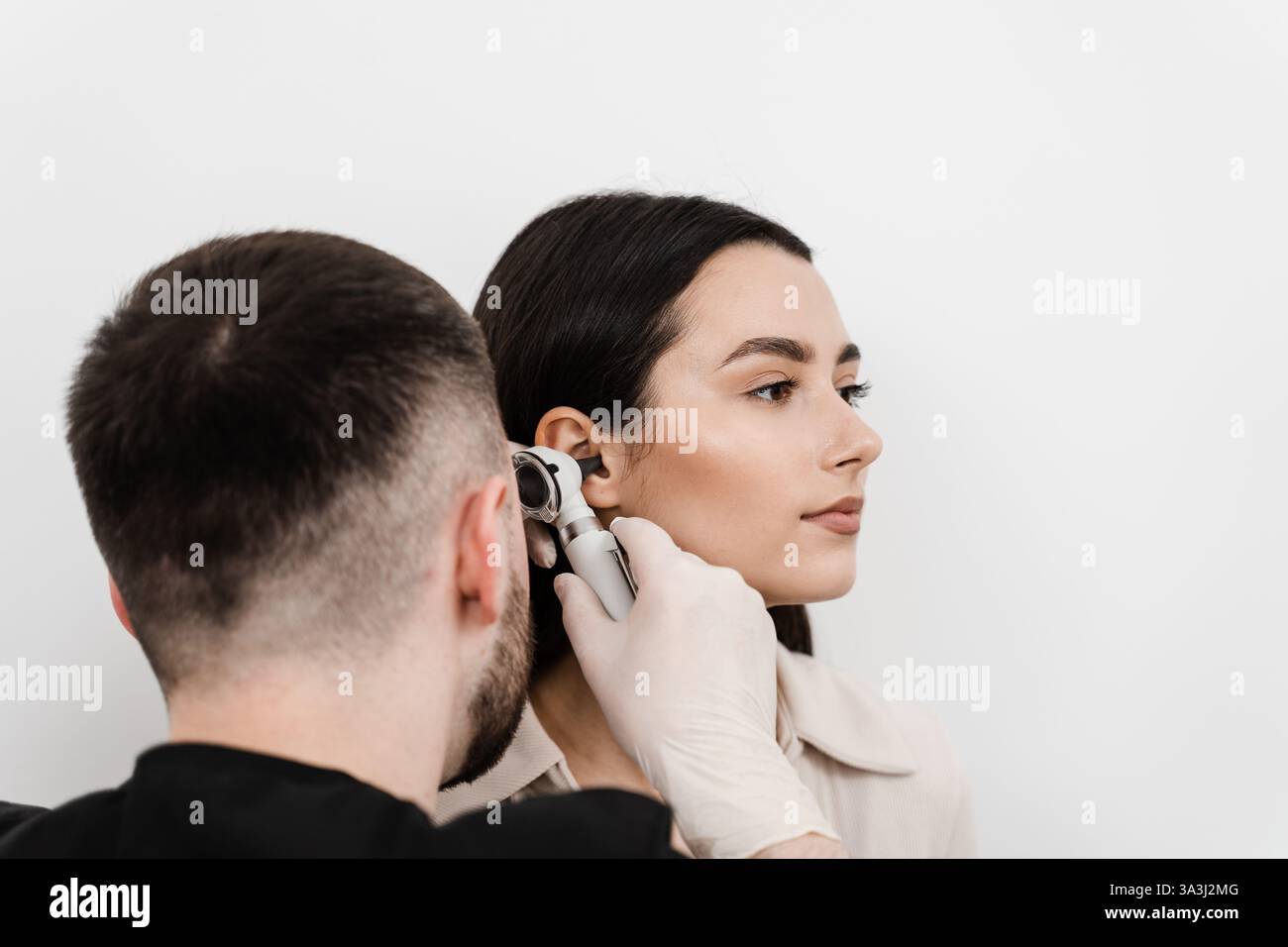 Otoscopy of ears with otoscope. ENT doctor. Consultation with ...