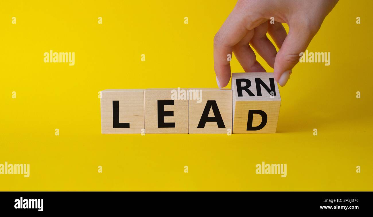 Learn and Lead symbol. Businessman hand Turnes cube and changes word ...