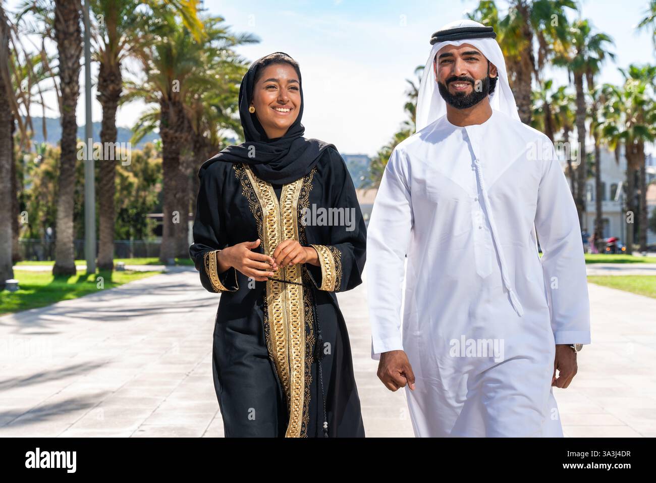 Traditional arab couple wearing emirati clothing dating outdoors - Middle-eastern married woman ...