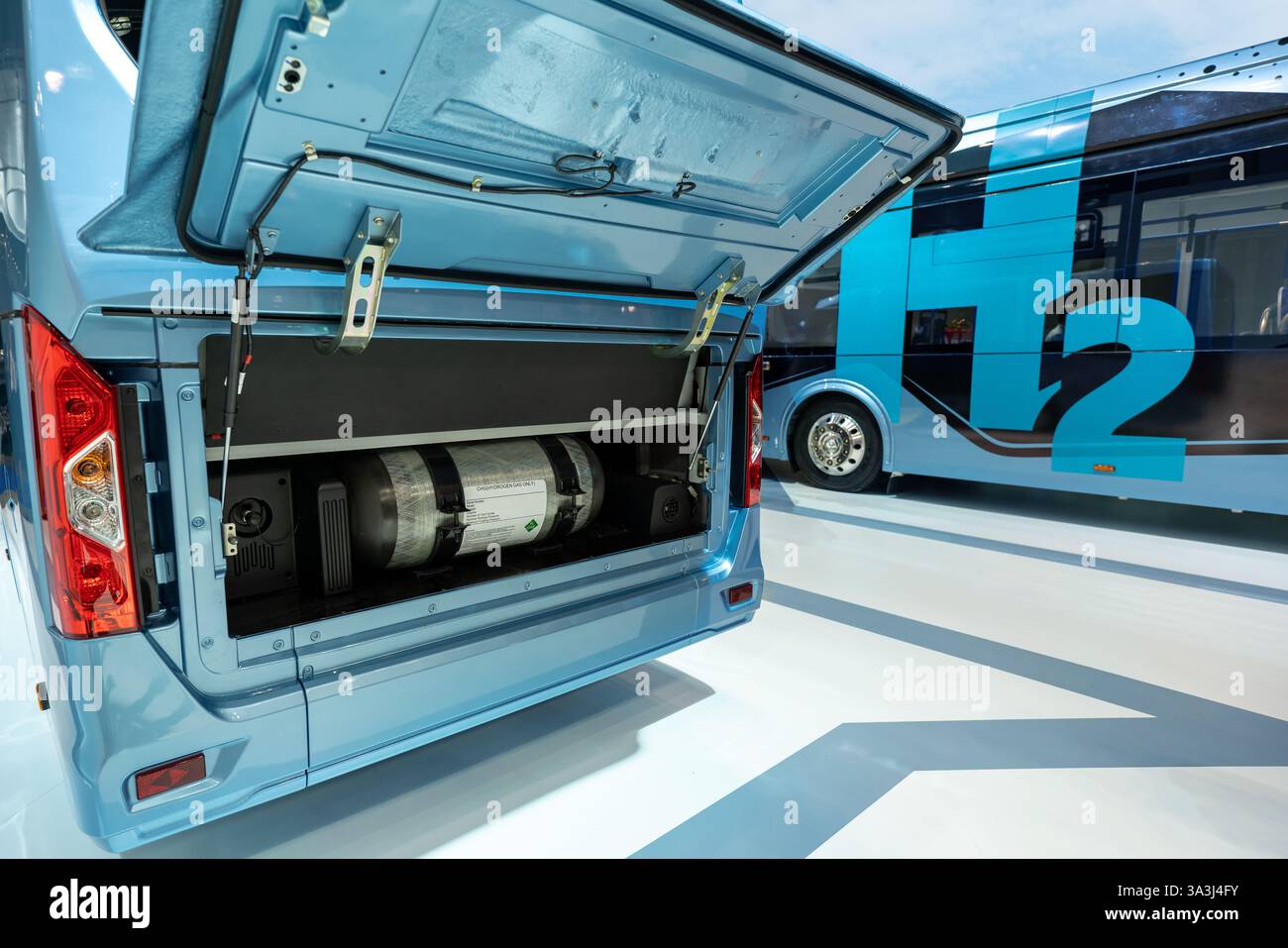 A hydrogen fuel cell buses. One bus with an open hood and a hydrogen ...