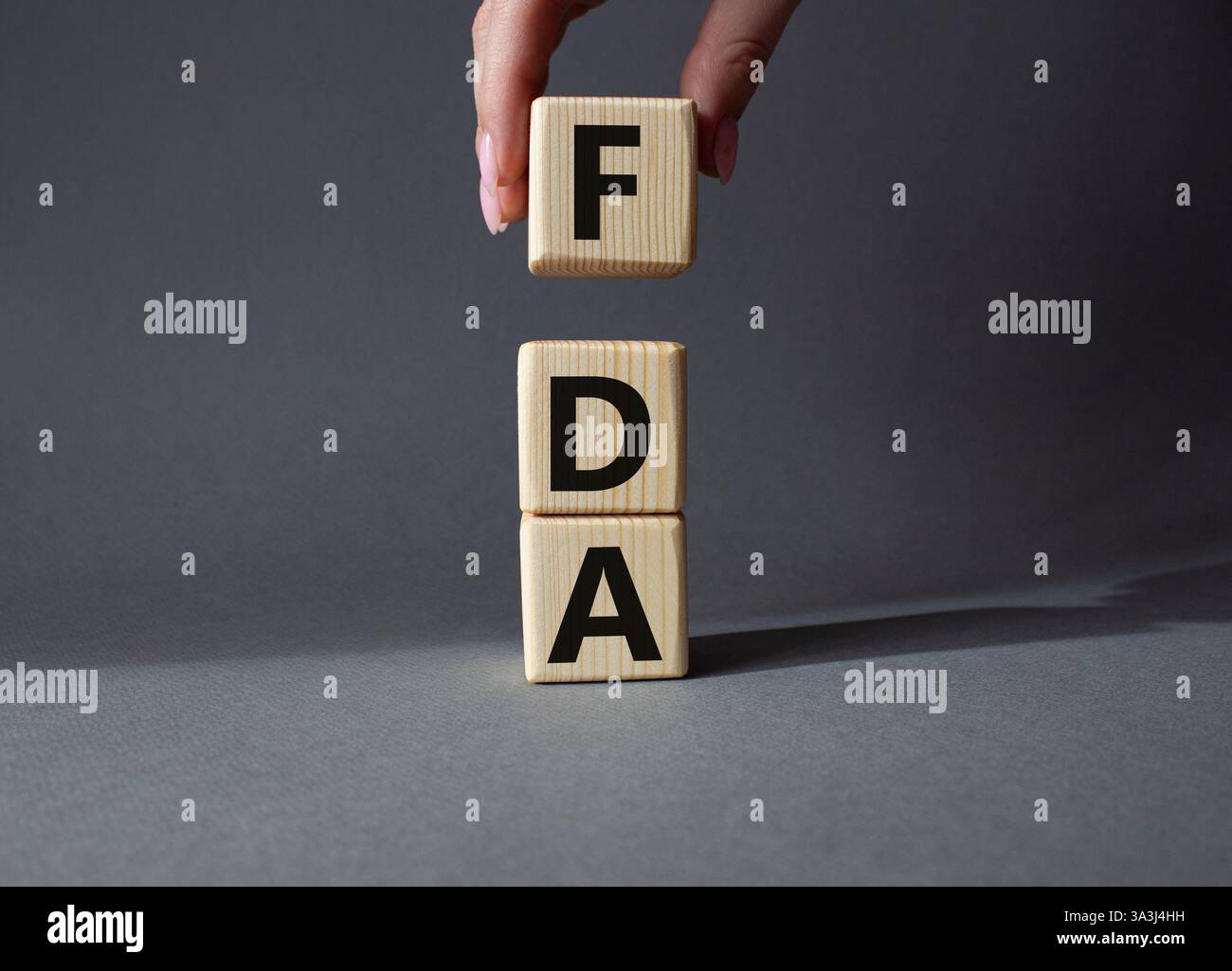 FDA - Food Drug Administration symbol. Wooden cubes with word FDA ...