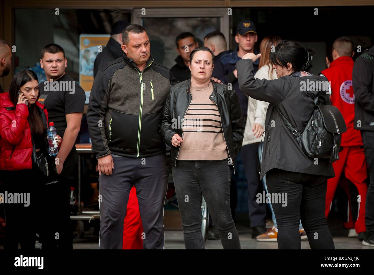 People wait outside a hospital in the town of Kocani, North Macedonia ...