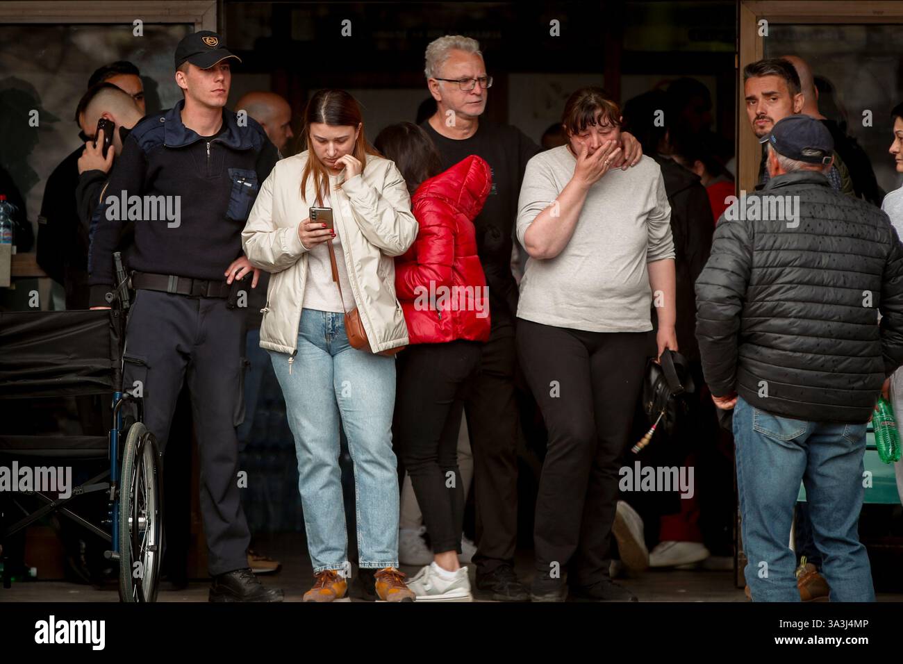 People wait outside a hospital in the town of Kocani, North Macedonia ...