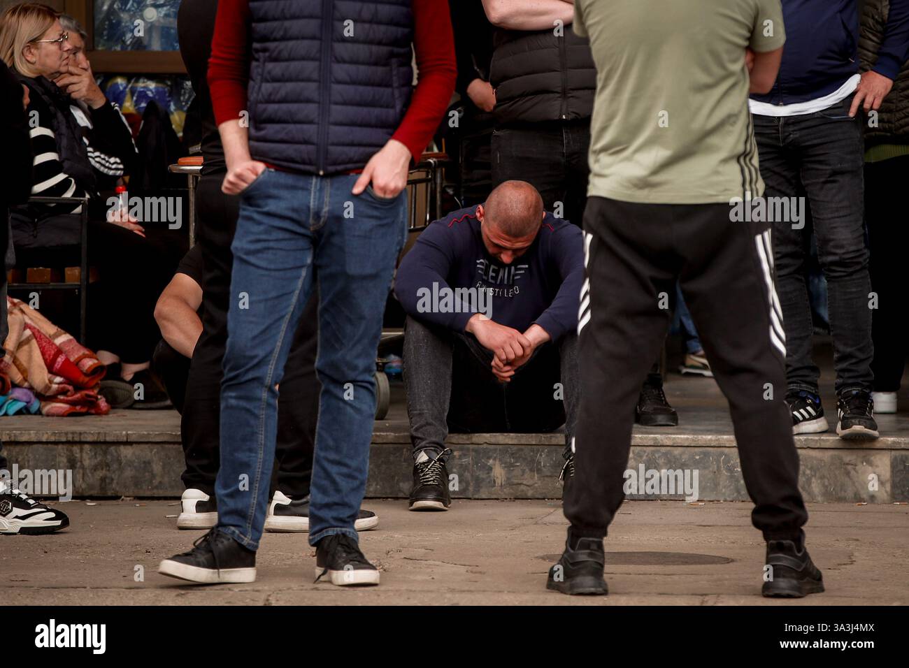 People wait outside a hospital in the town of Kocani, North Macedonia, Sunday, March 16, 2025 ...