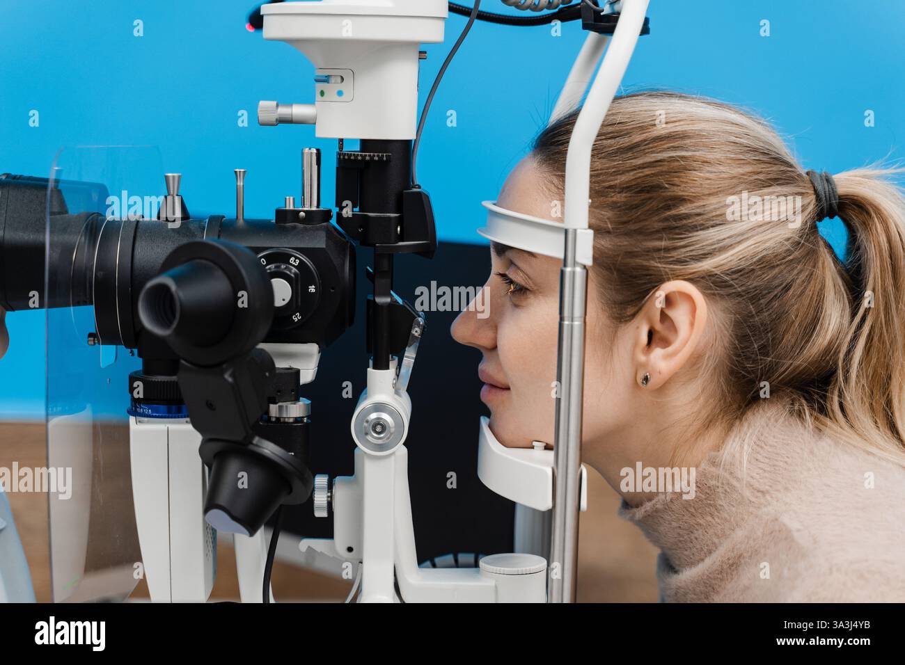 Ophthalmologist with slit lamp examines eyes and cornea of woman ...
