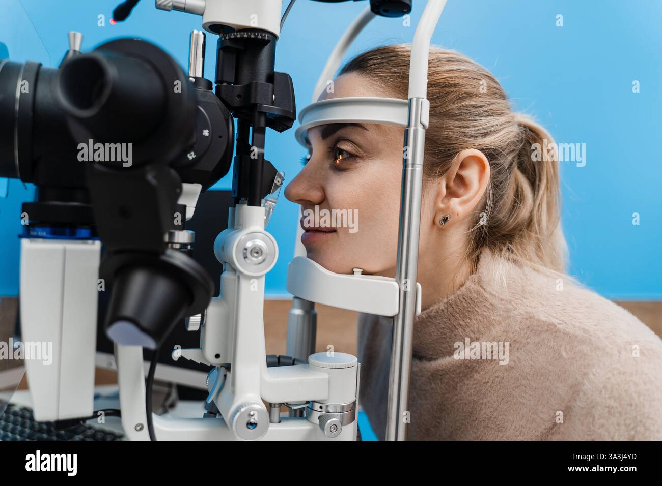 Ophthalmologist illuminates eye of child with light from slit lamp to ...