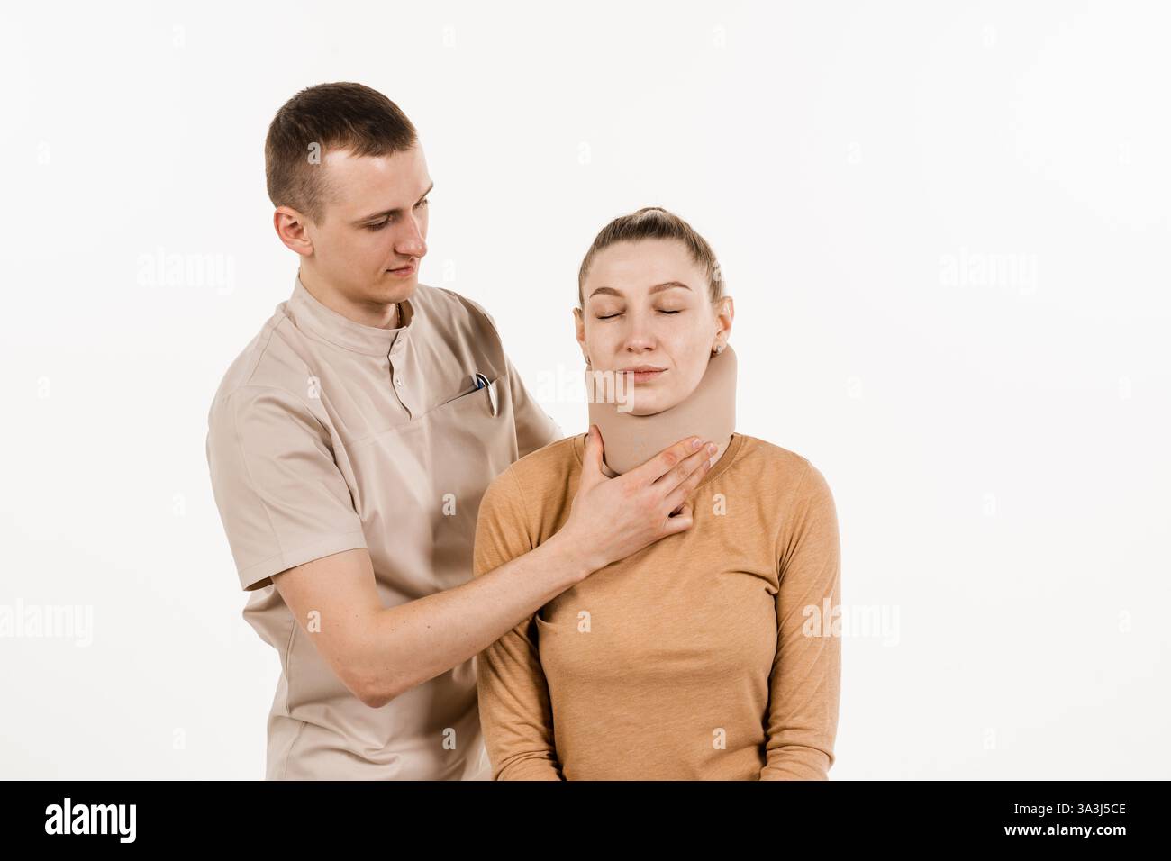 Traumatologist puts soft collar or bandage on girl to stabilize ...