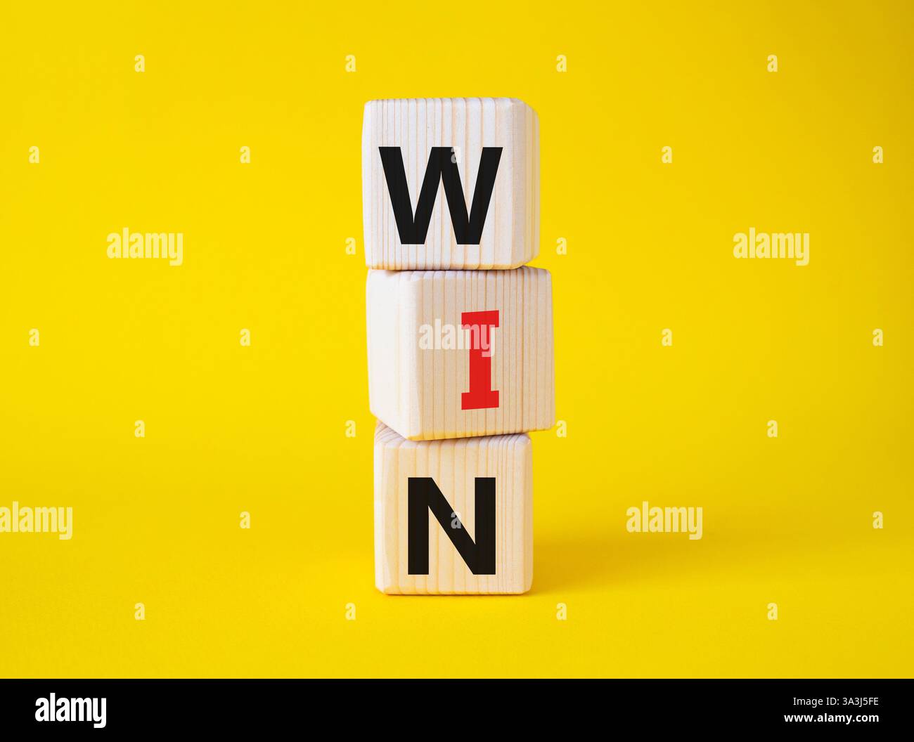 Win symbol. Wooden blocks with words Win. Beautiful yellow background ...