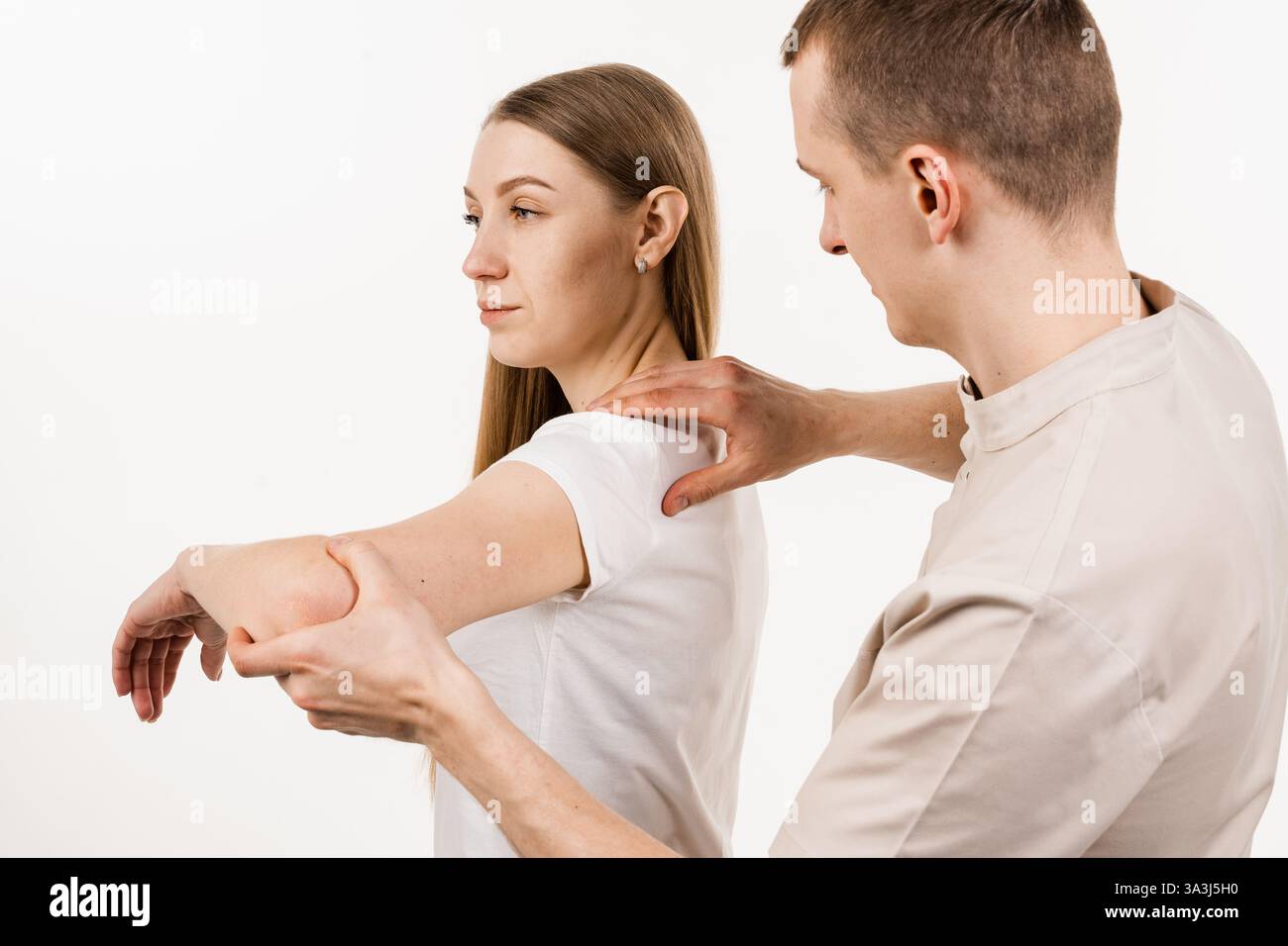 Orthopedic traumatologist examines shoulder joint of patient and checks ...