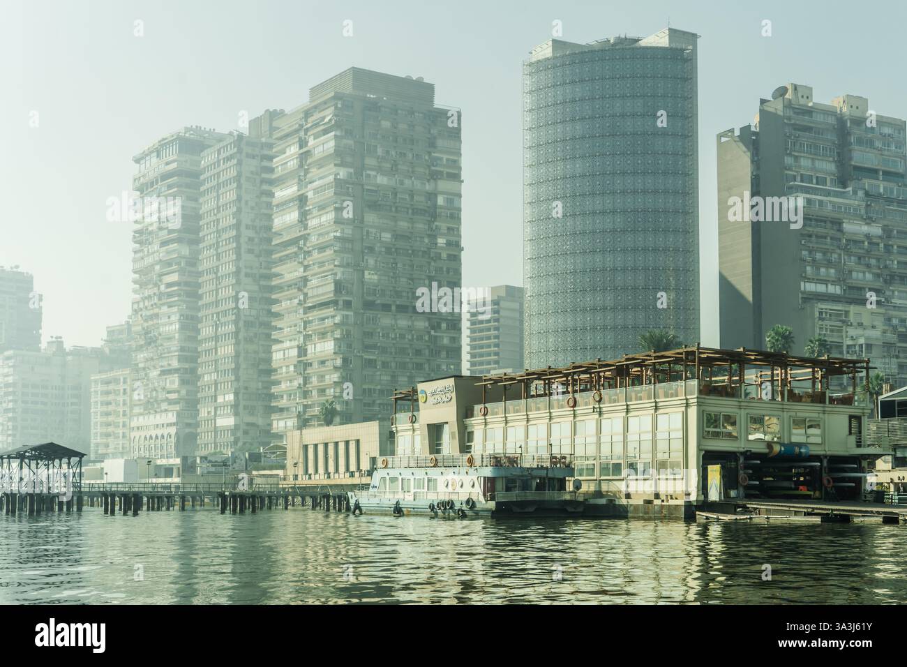 The skyline of Cairo is shrouded in hazy smoke, view from the boat on ...