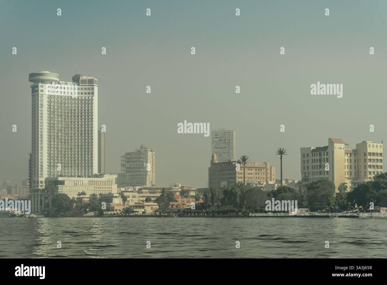 The skyline of Cairo is shrouded in hazy smoke, view from the boat on ...