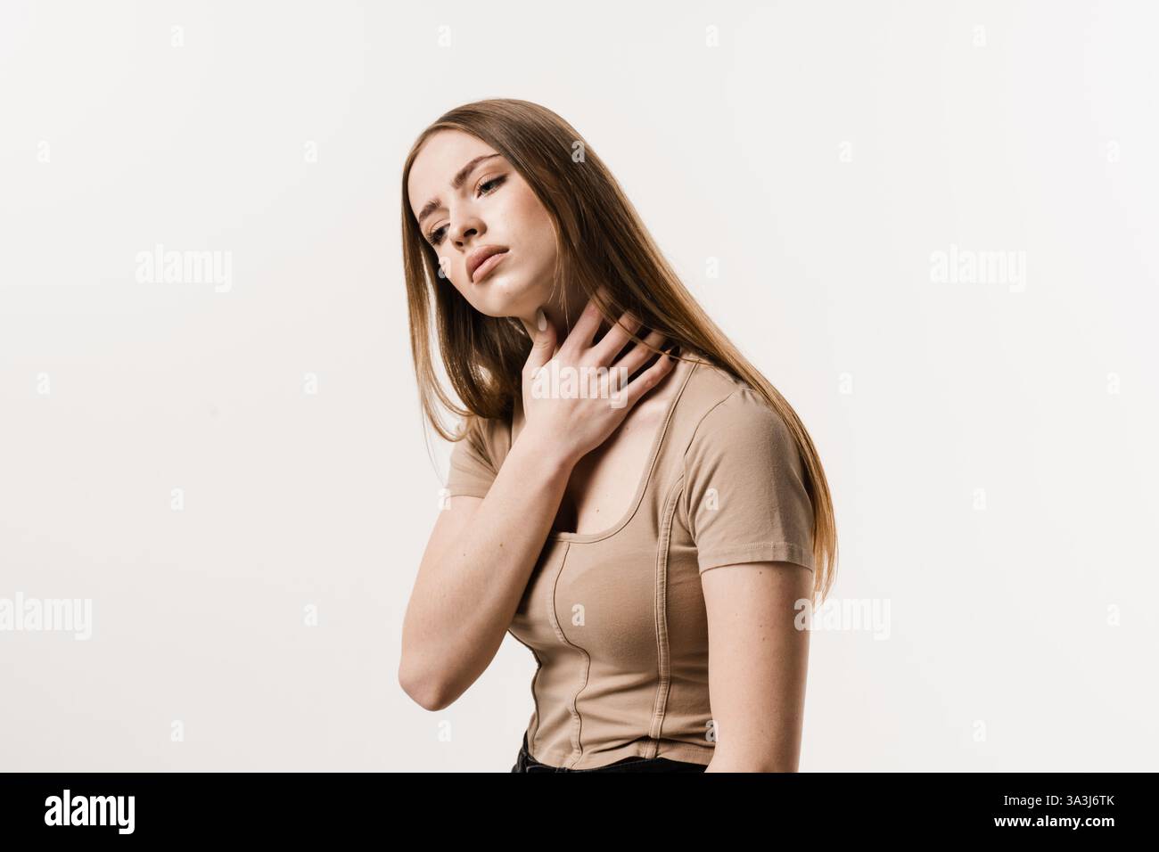 Sick girl touches throat with pain on white background. Laryngitis ...