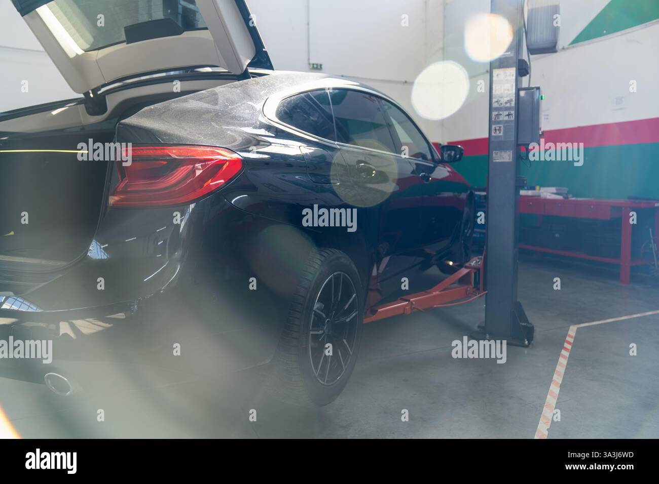 Car service workshop with cars on a column lifts Stock Photo - Alamy