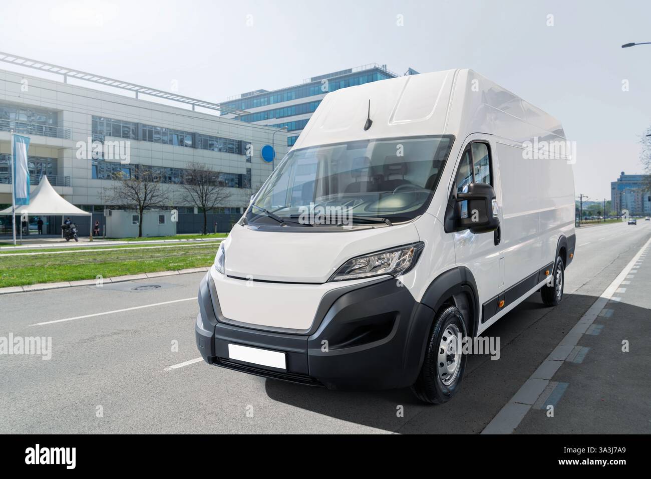White delivery van on city street Stock Photo - Alamy