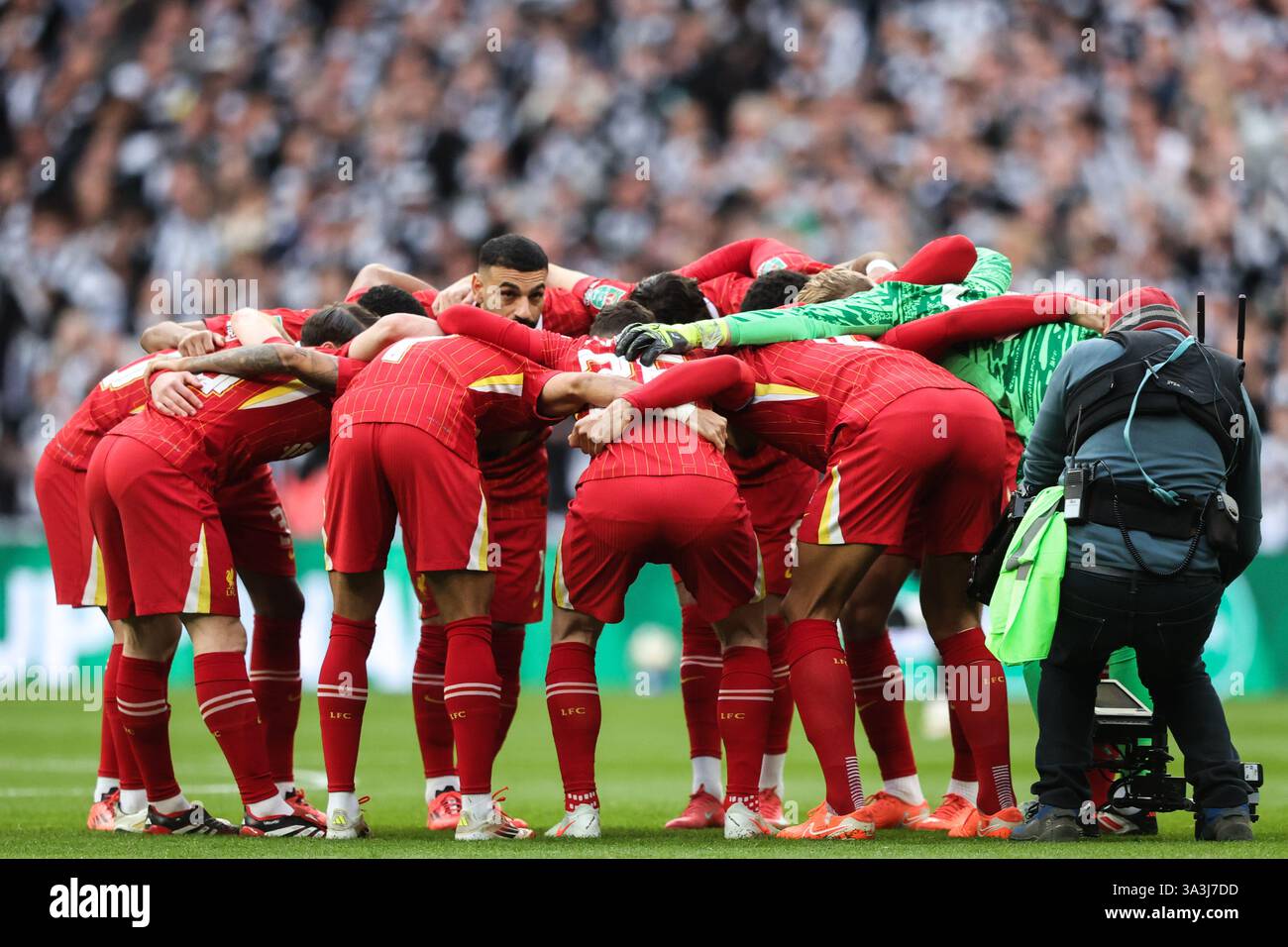 Liverpool players form a huddle during the Carabao Cup Final match ...