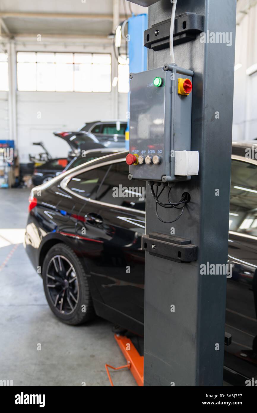Car service workshop with cars on a column lifts Stock Photo - Alamy