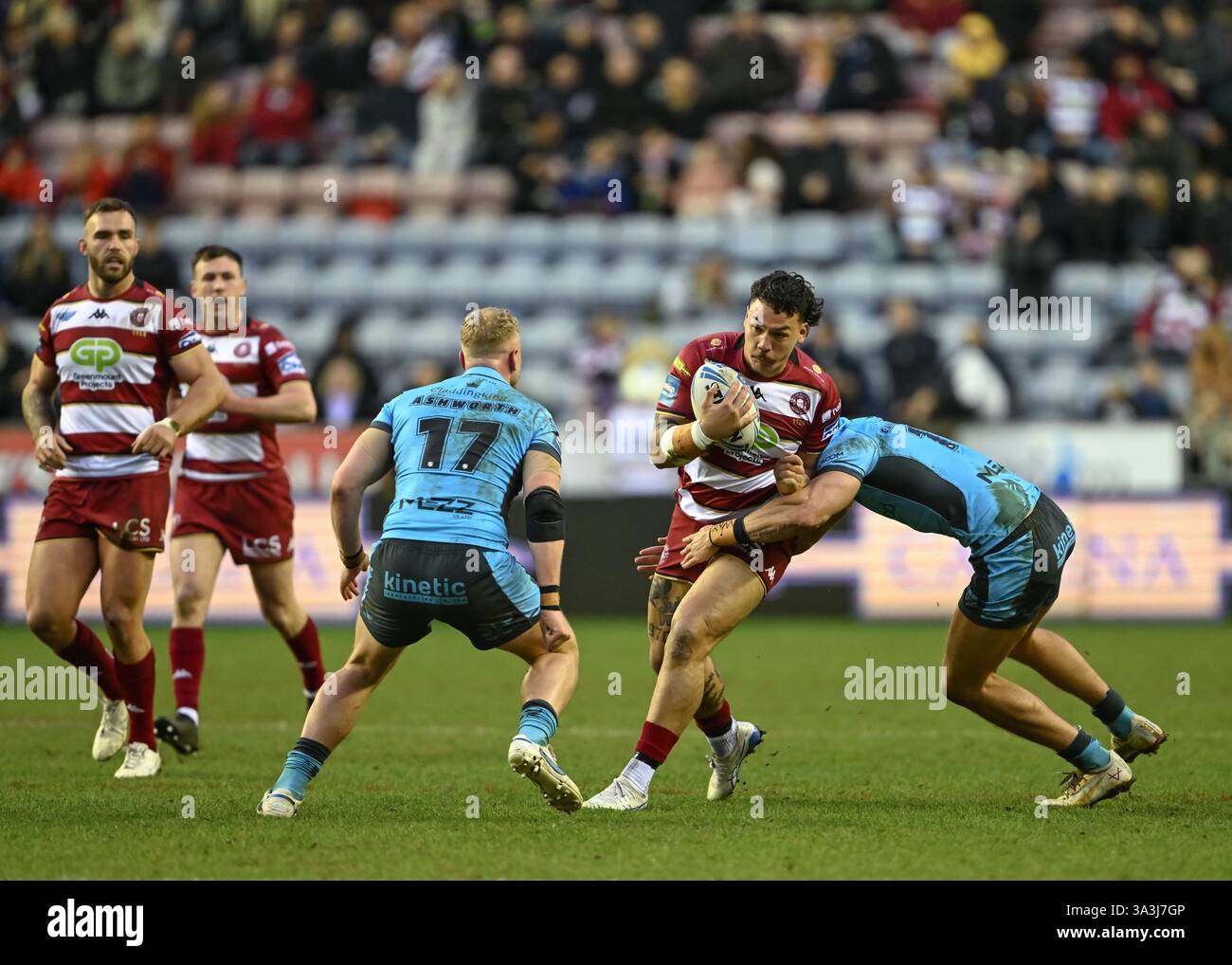 Wigan Warriors' Tyler Dupree is tackled by Hull FC's Jed Cartwright ...