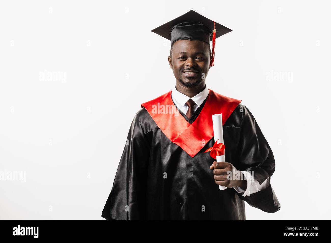 Happy african student in black graduation gown and cap raises masters ...