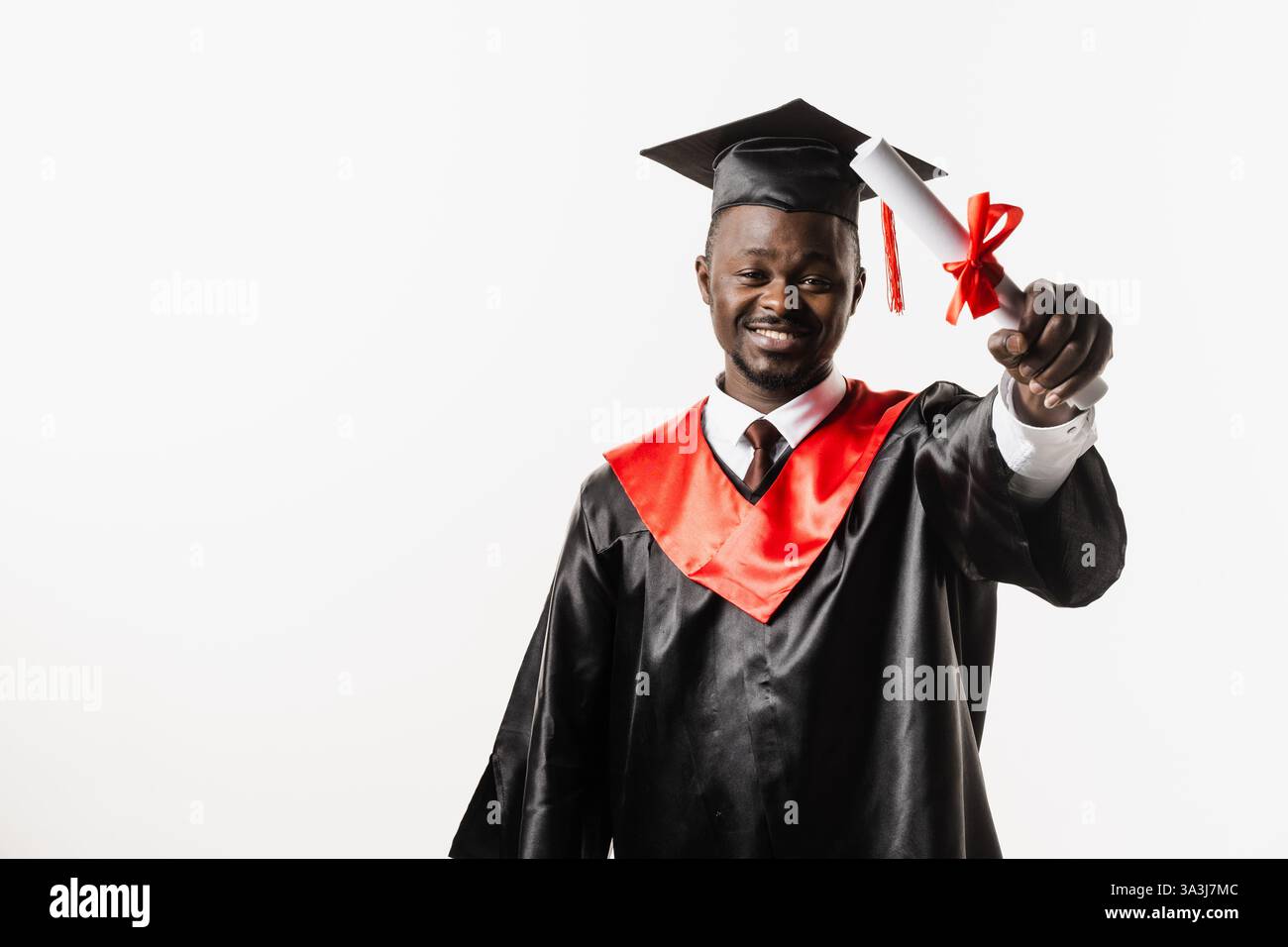 Happy african student in black graduation gown and cap raises masters ...