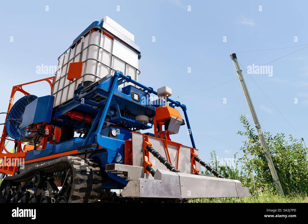 Autonomous robot sprayer works in a fruit garden. Smart farming concept ...