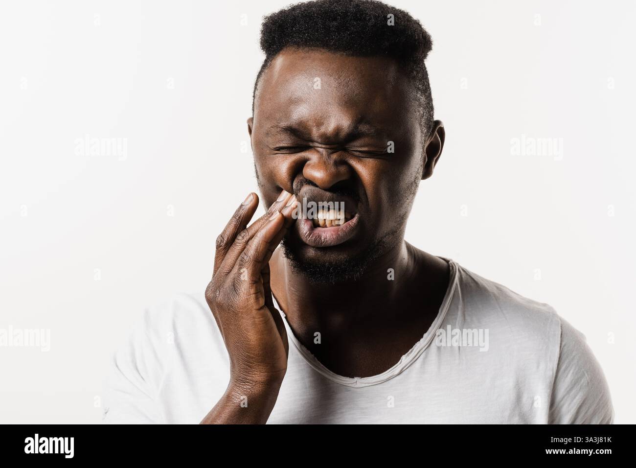 African american man is touching cheek and feeling toothache pain and ...