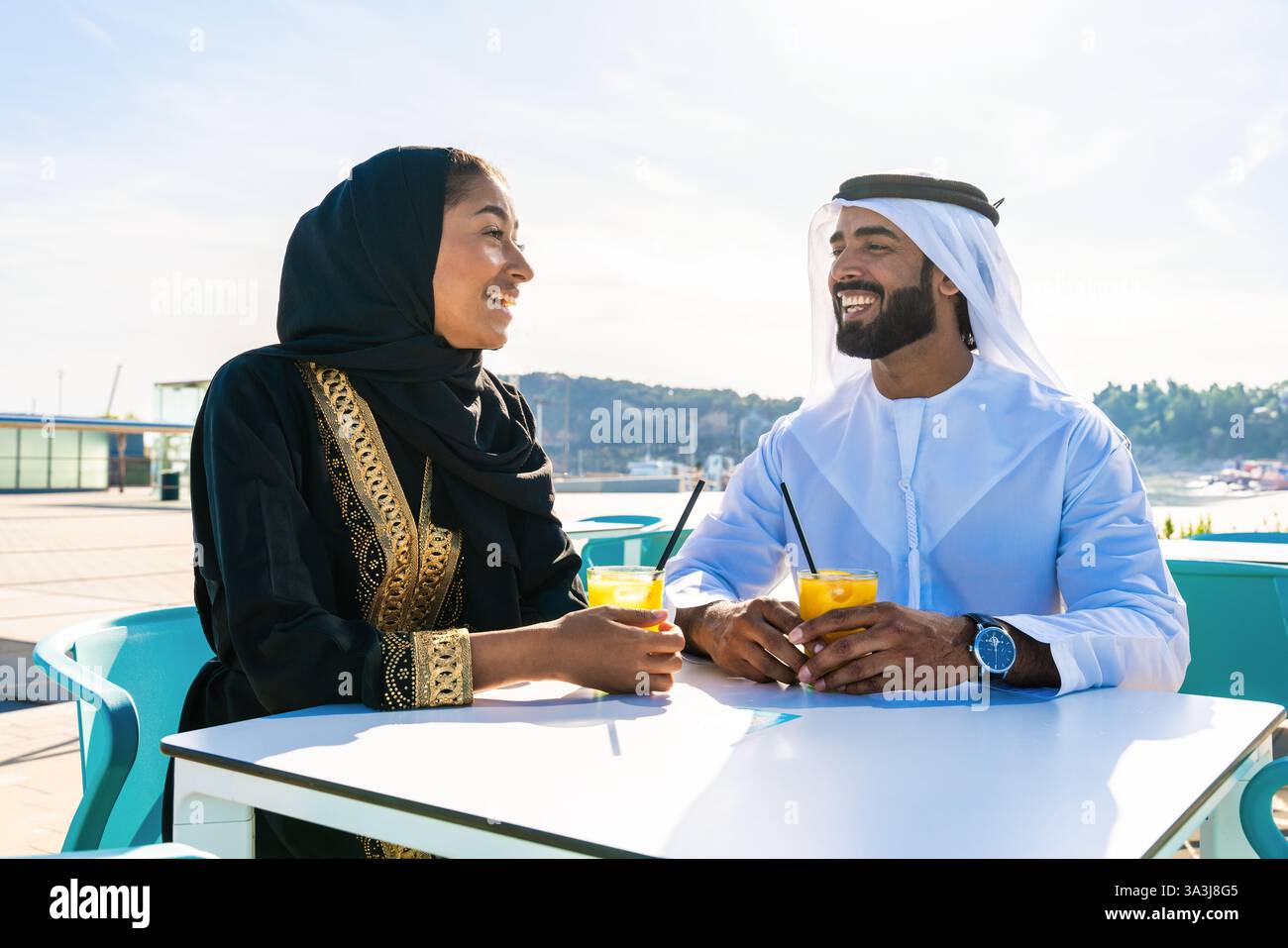 Traditional arab couple wearing emirati clothing dating outdoors - Middle-eastern married woman ...