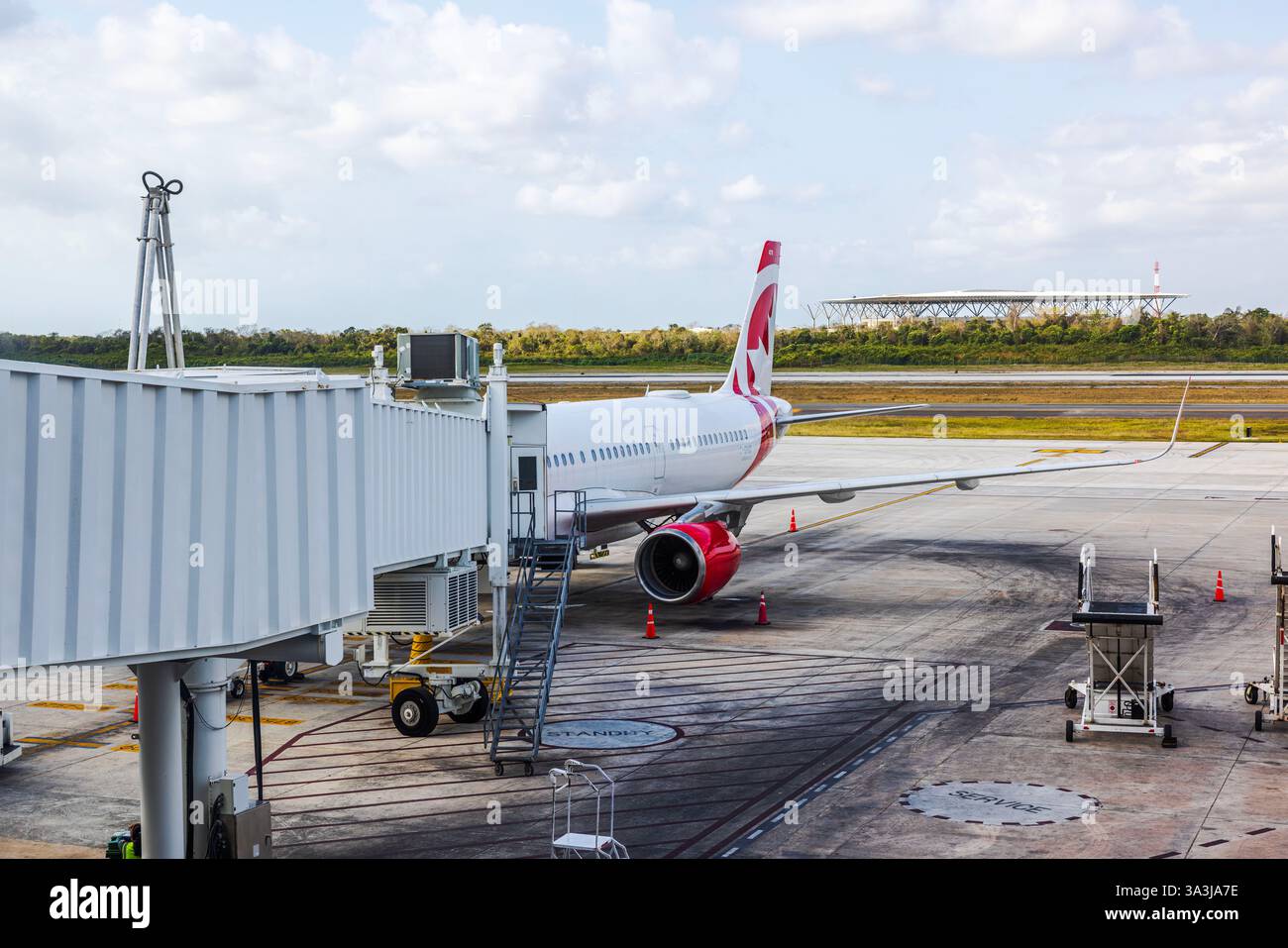 Airplane parked at airport terminal with jet bridge connected for ...