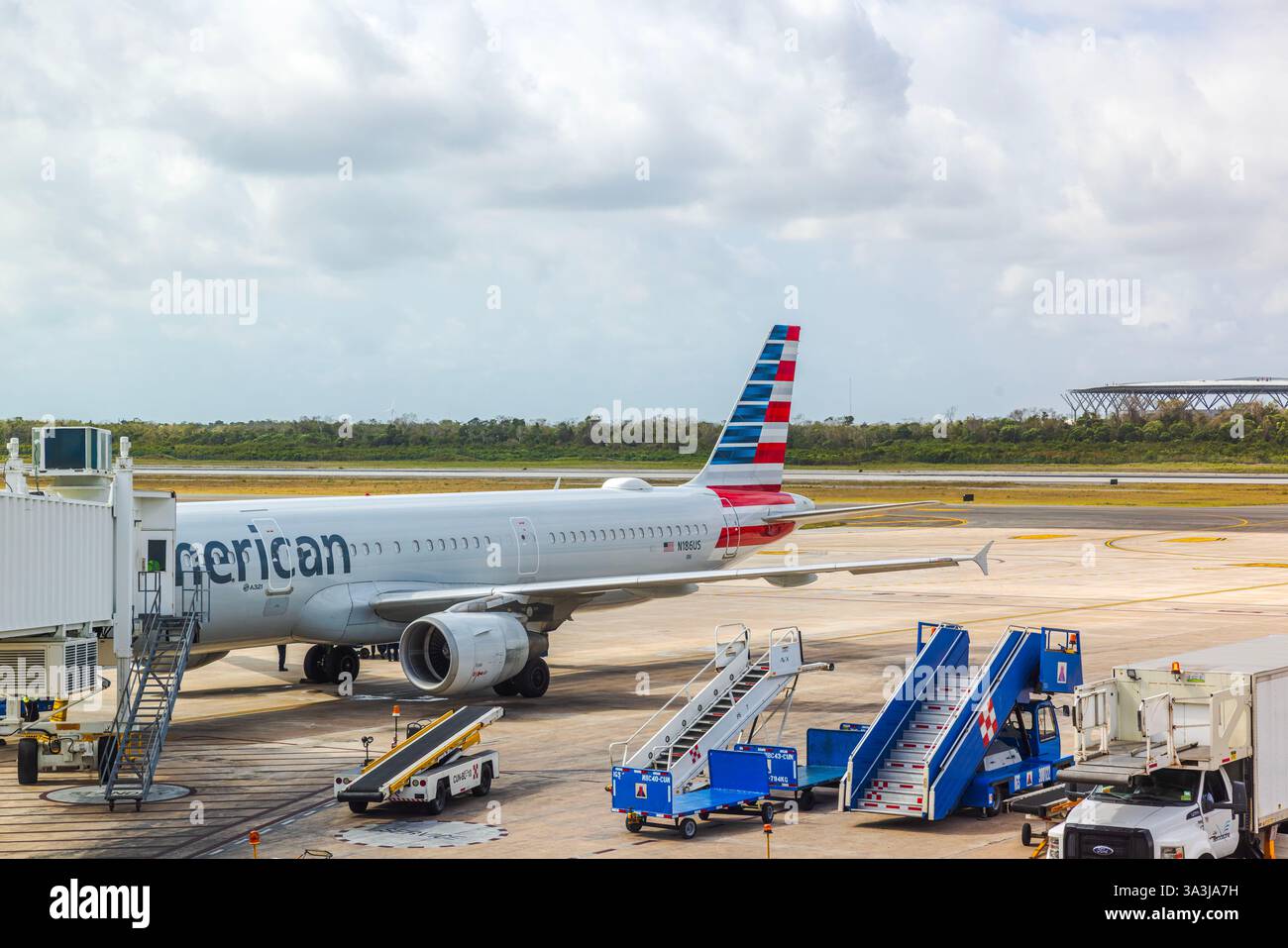 American Airlines aircraft parked at airport gate with connected jet ...