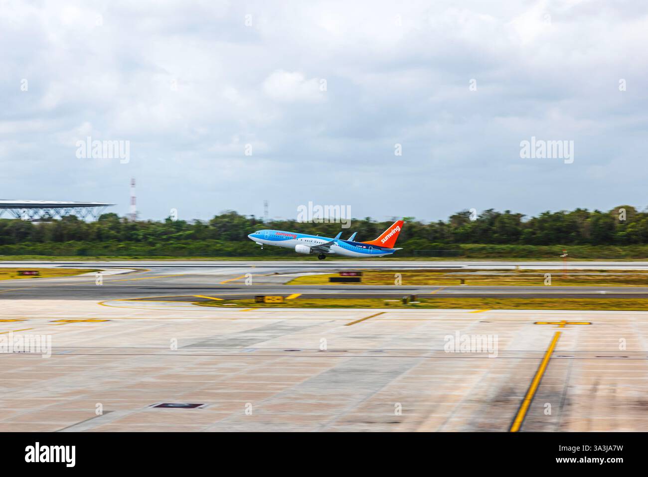 Sunwing Airlines aircraft lifting off from runway at Cancun airport ...