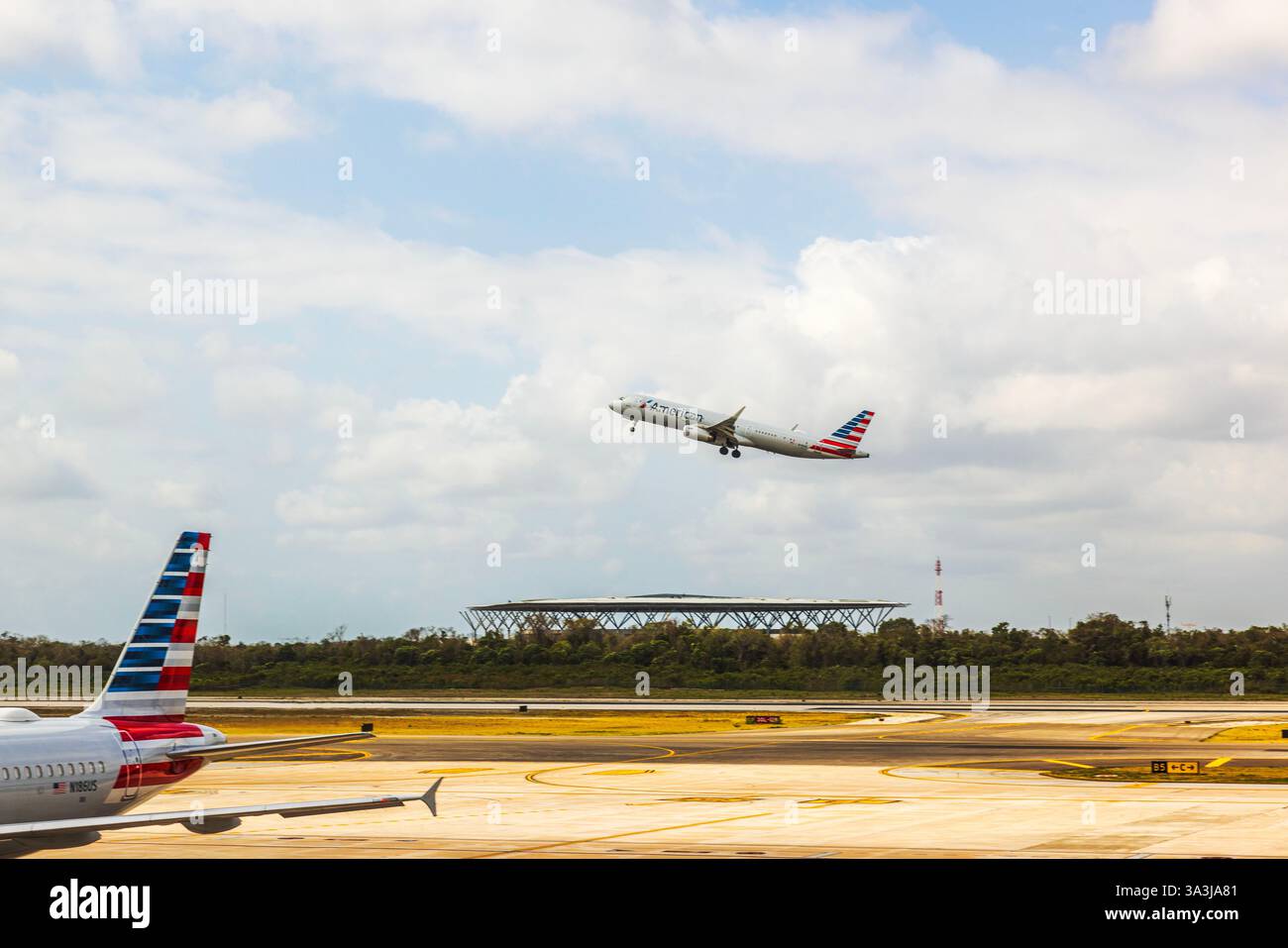 American Airlines aircraft ascending after takeoff at Cancun airport ...