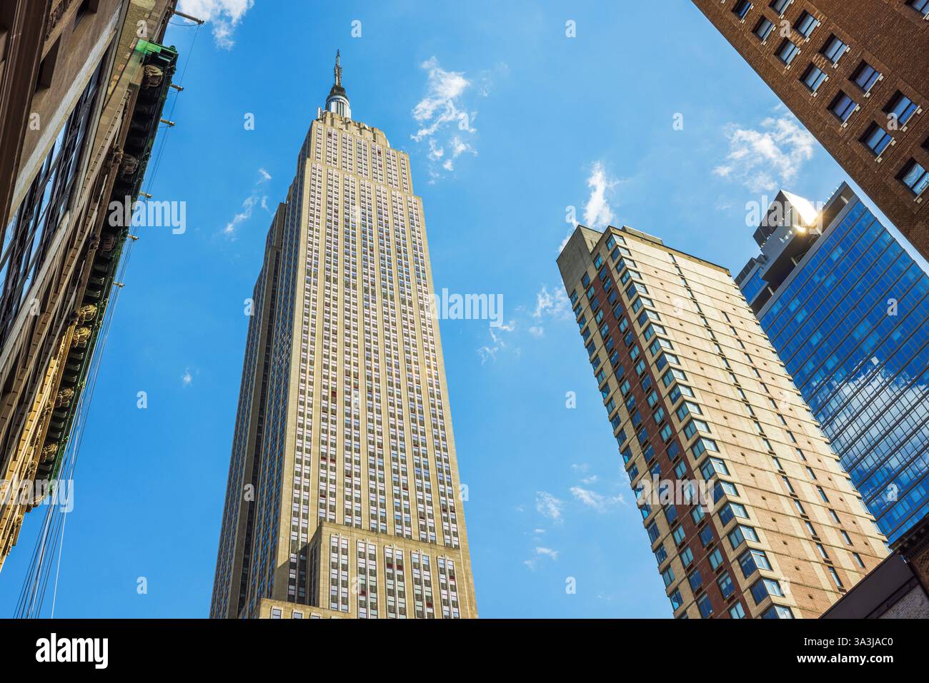 Low-angle view of the Empire State Building towering over Manhattan ...