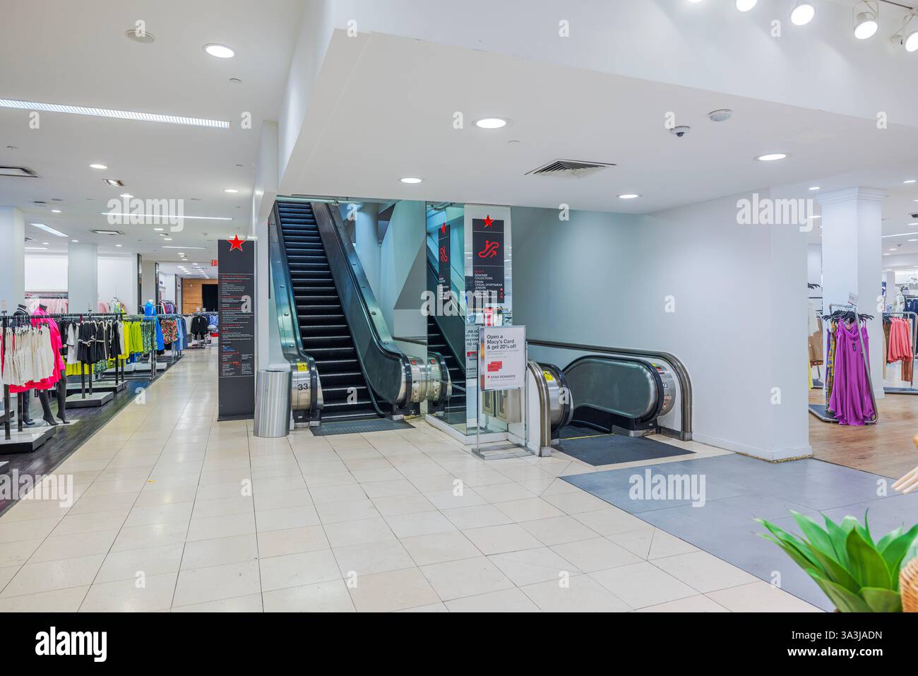 Escalators and clothing displays in Macys department store interior ...