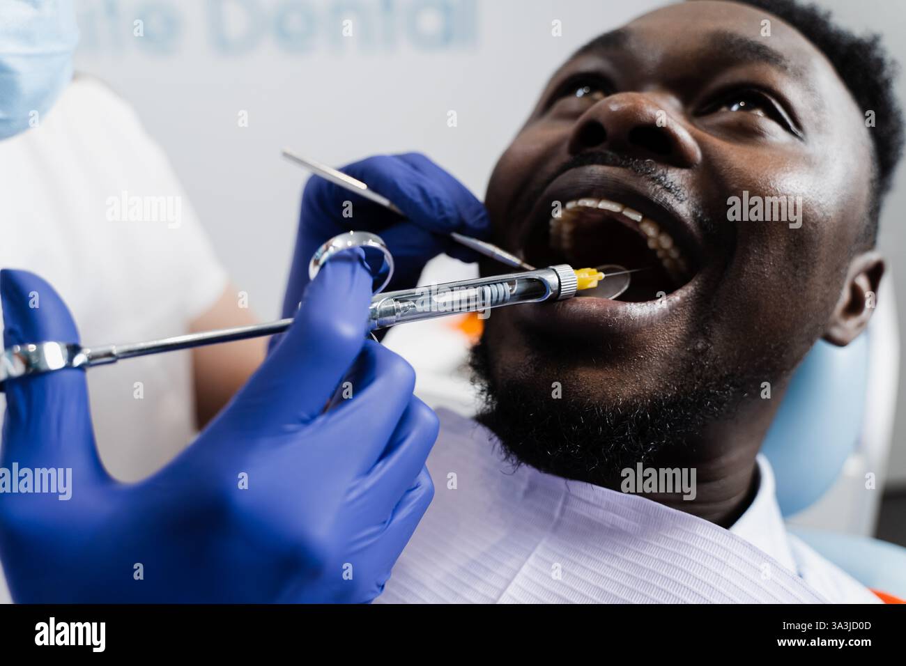 Dentist injects anesthesia syringe of the diseased teeth for the ...