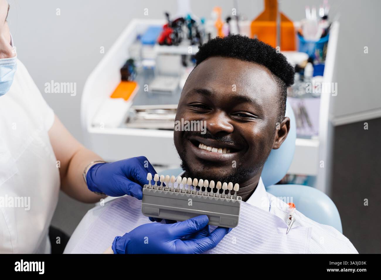 Dentist showing teeth color shades guide for tooth whitening for ...