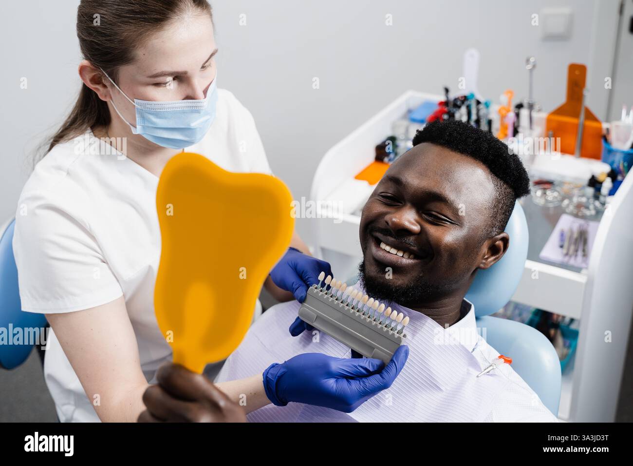 African is looking at veneers or implants teeth color matching samples ...