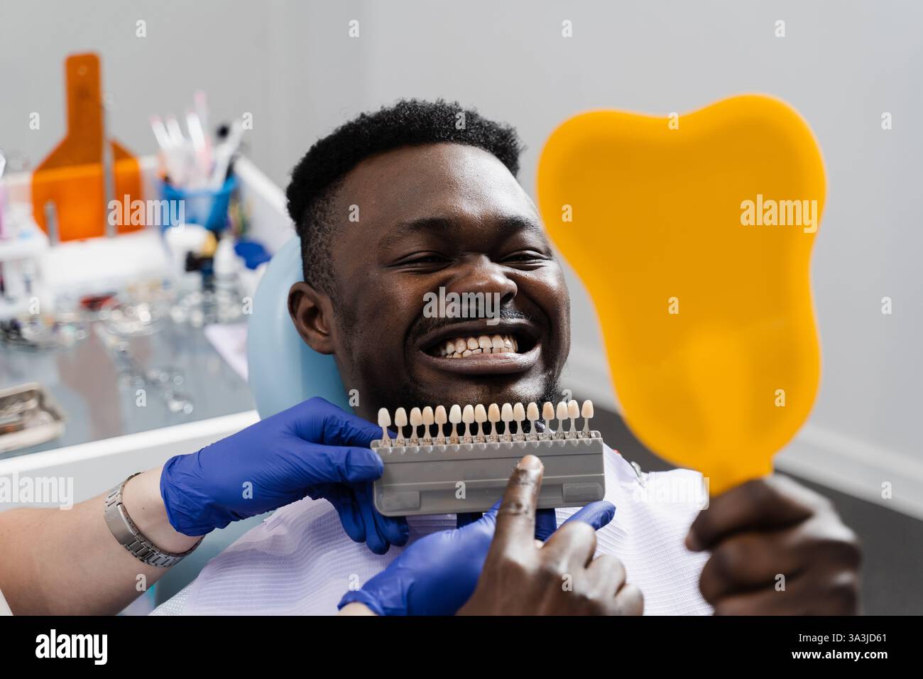 Dentistry. Dentist showing teeth color shades guide for tooth whitening ...