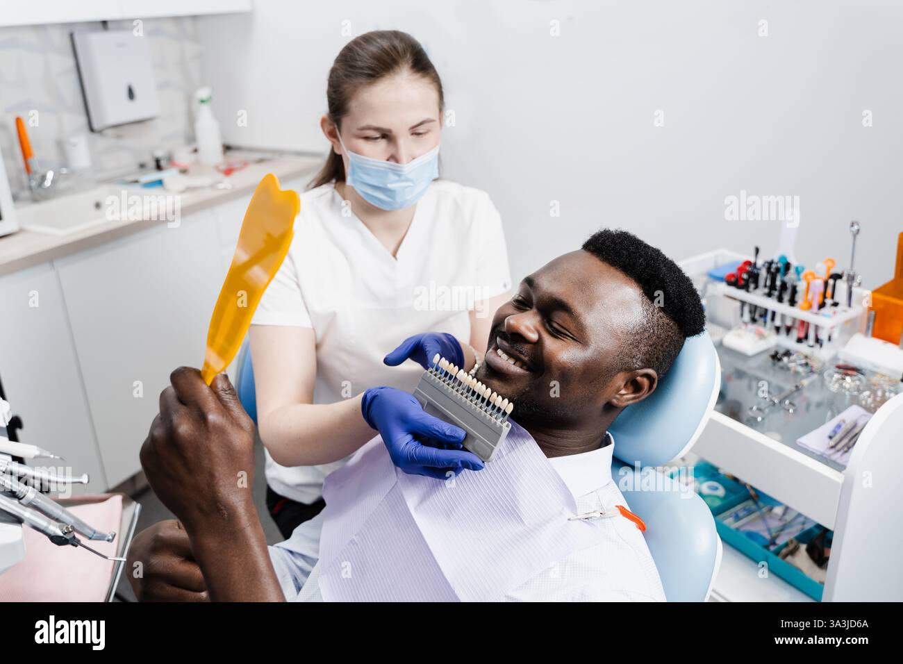 Dentistry. Doctor checking teeth color matching samples in dental ...