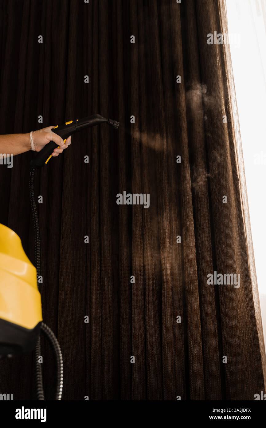Close-up process of disinfection and dry cleaning of curtains at home ...