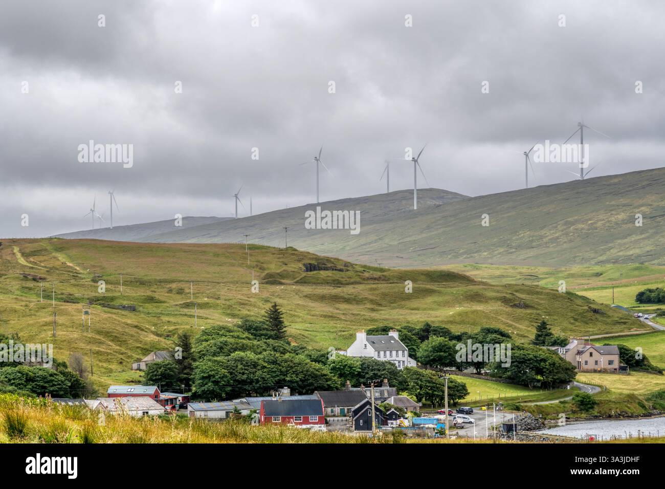 Wind turbines of the Viking wind farm seen behind the village of Voe on ...