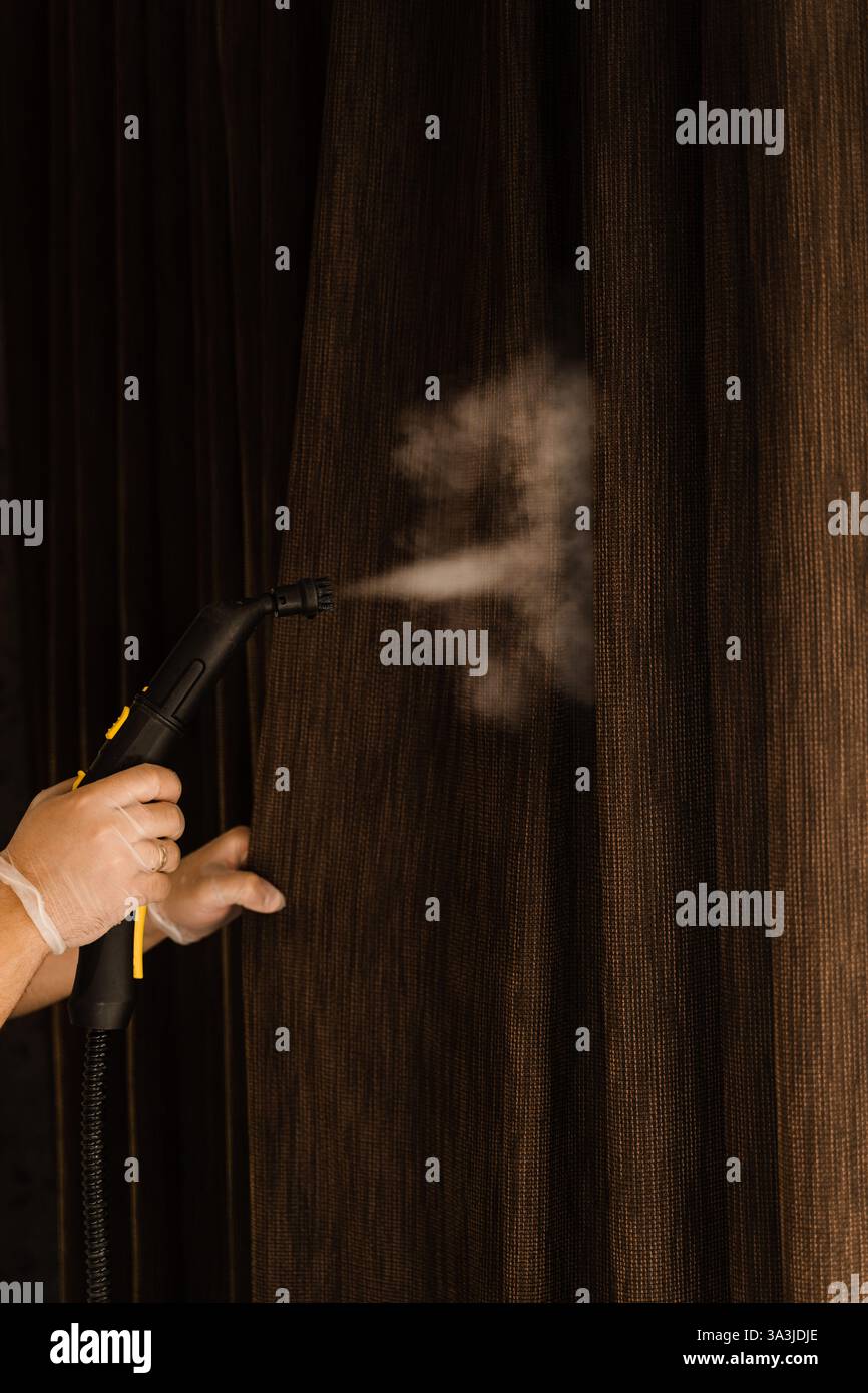 Close-up curtains dry wash using steam machine at home. Steaming of ...