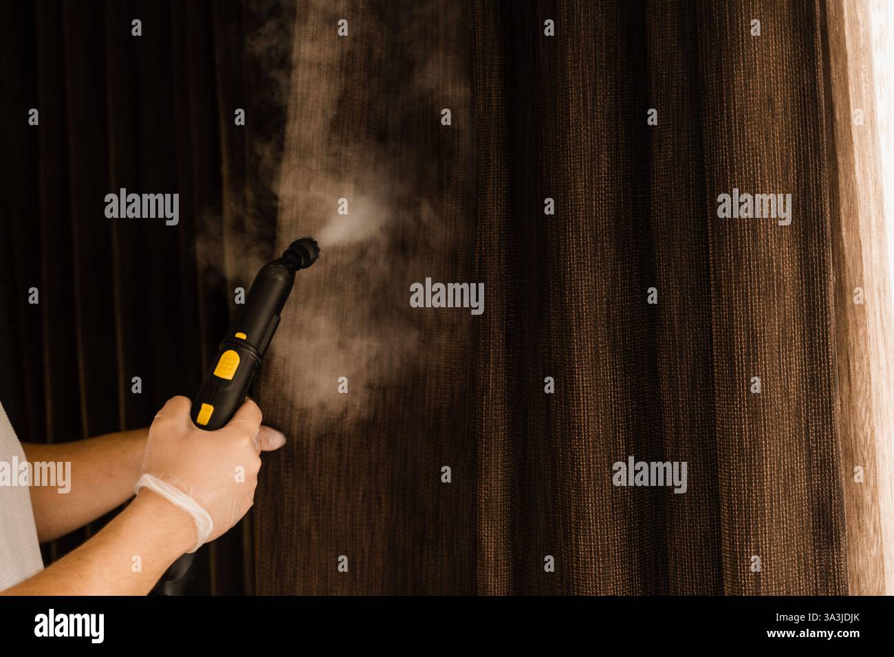 Close-up process of disinfection and dry cleaning of curtains at home ...