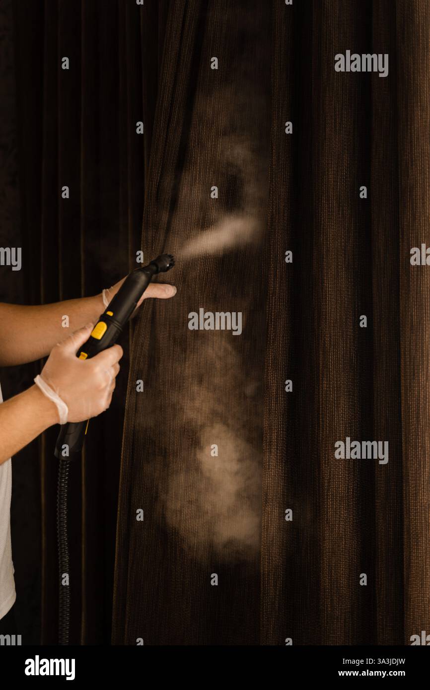 Close-up curtains dry wash using steam machine at home. Steaming of ...
