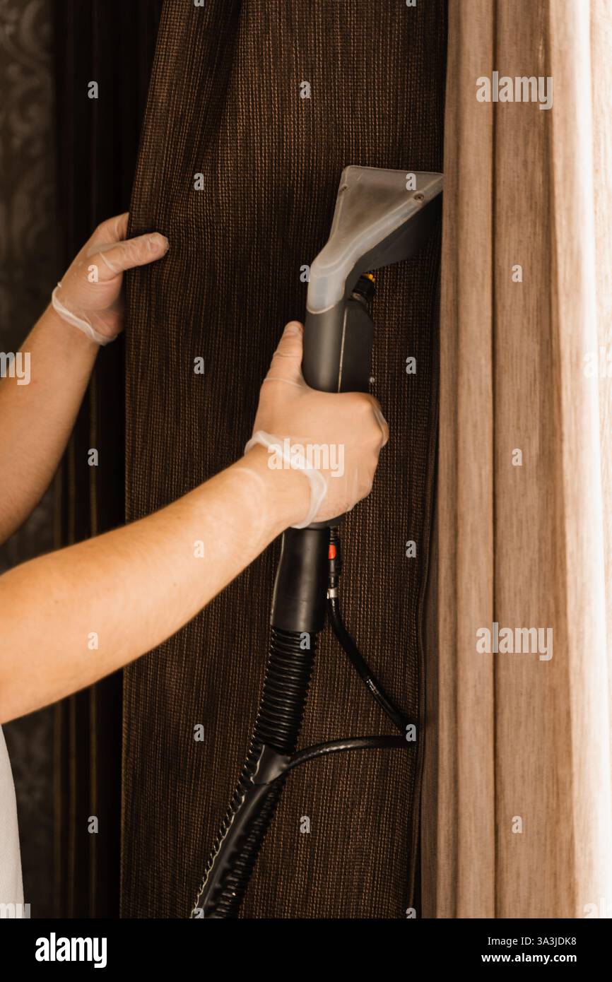 Cleaning curtains with extractor machine. Process of extracting dirt ...